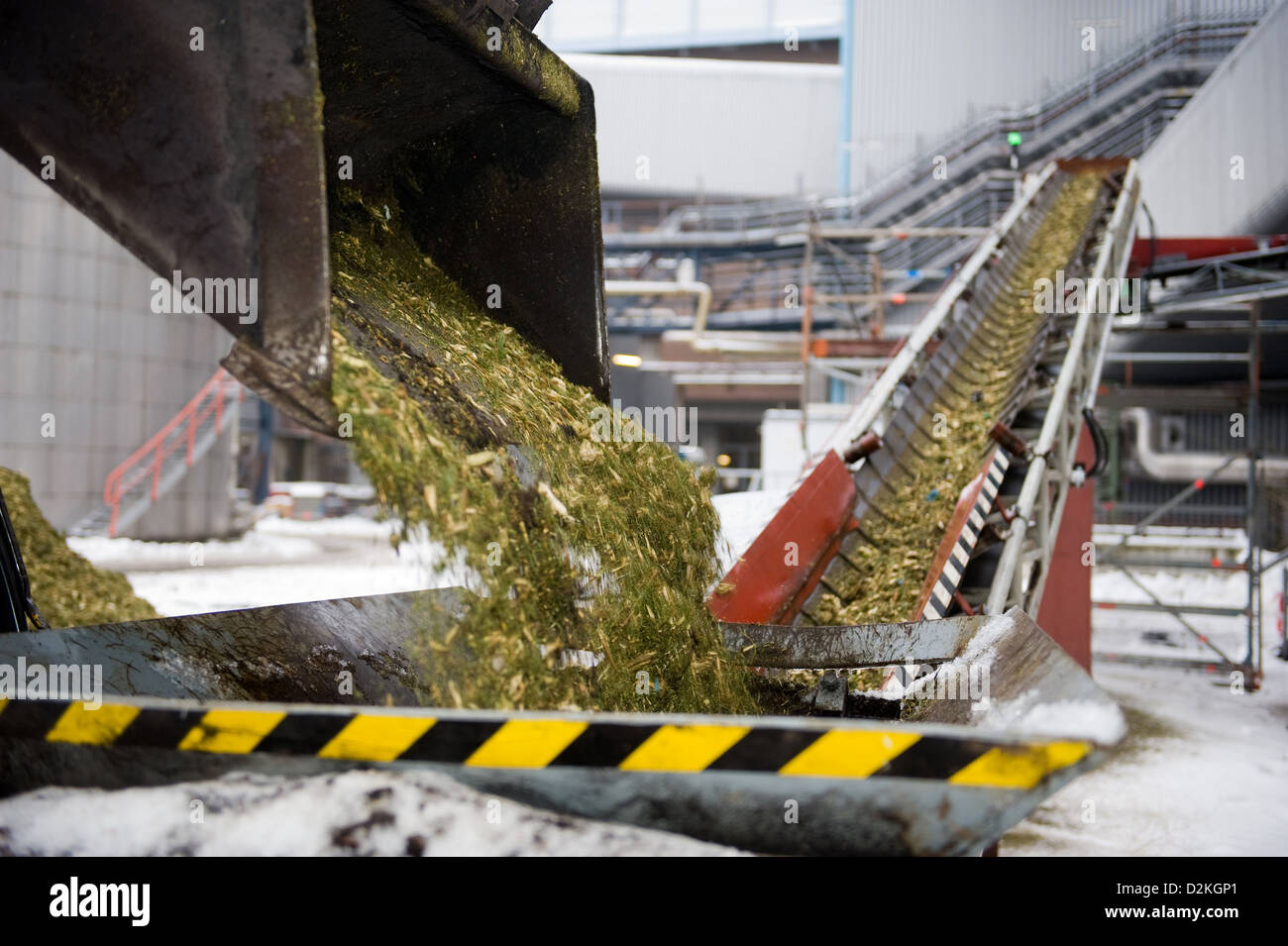 Berlin, Germany, a shovel invites wood chips on a conveyor belt Stock ...