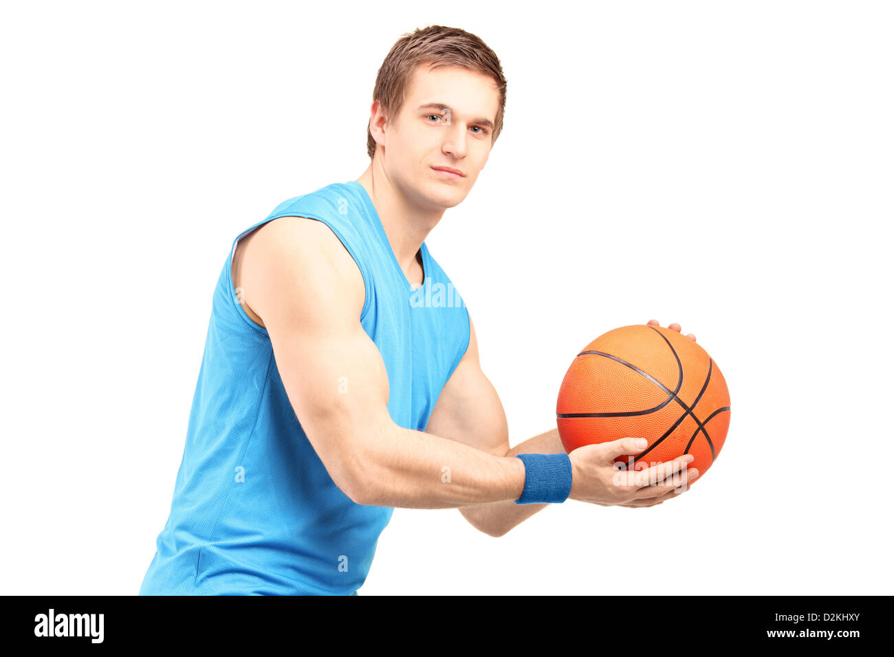 A male basketball player with basketball looking at camera isolated on ...