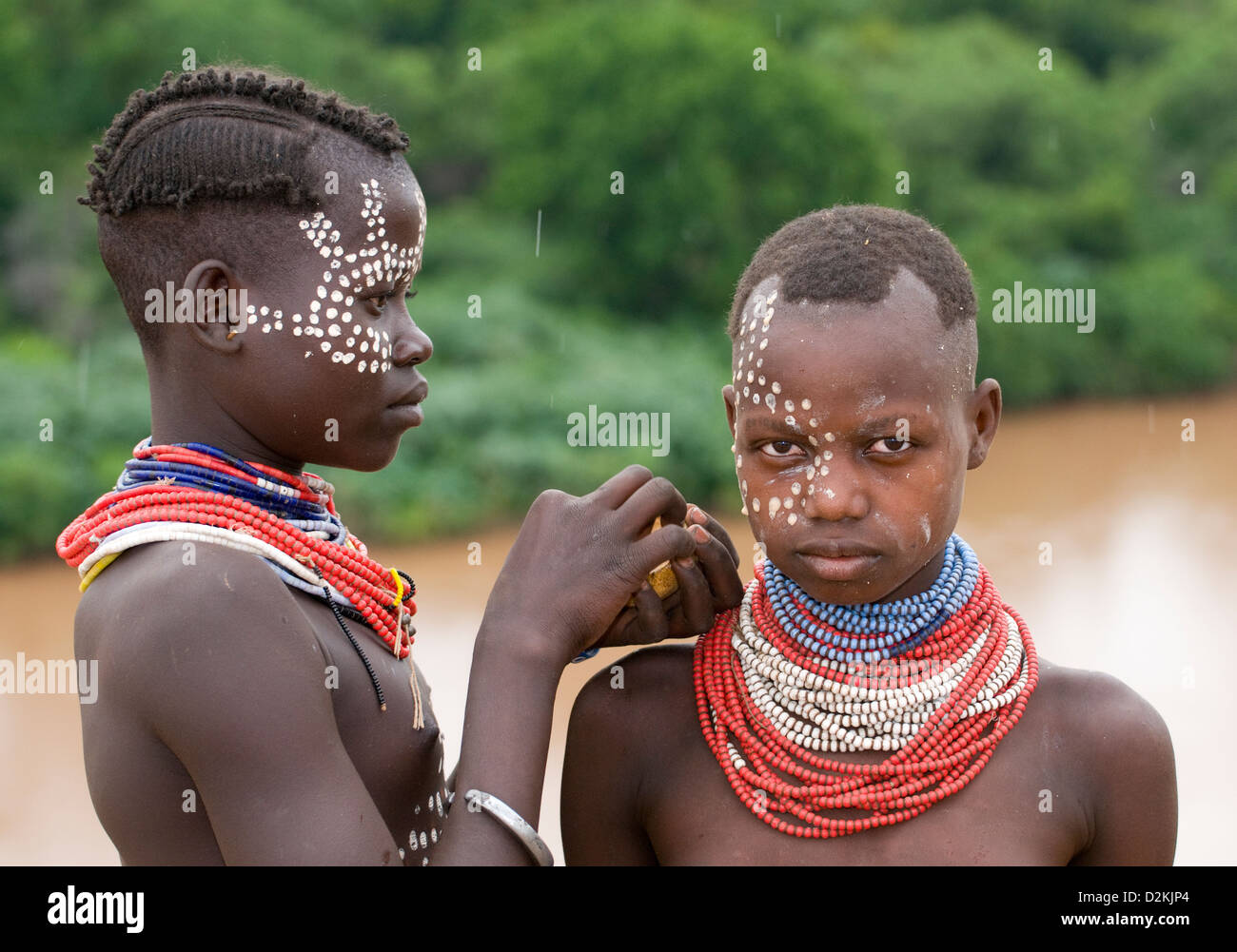 Portrait of decorated Kara woman being painted by other Stock Photo - Alamy