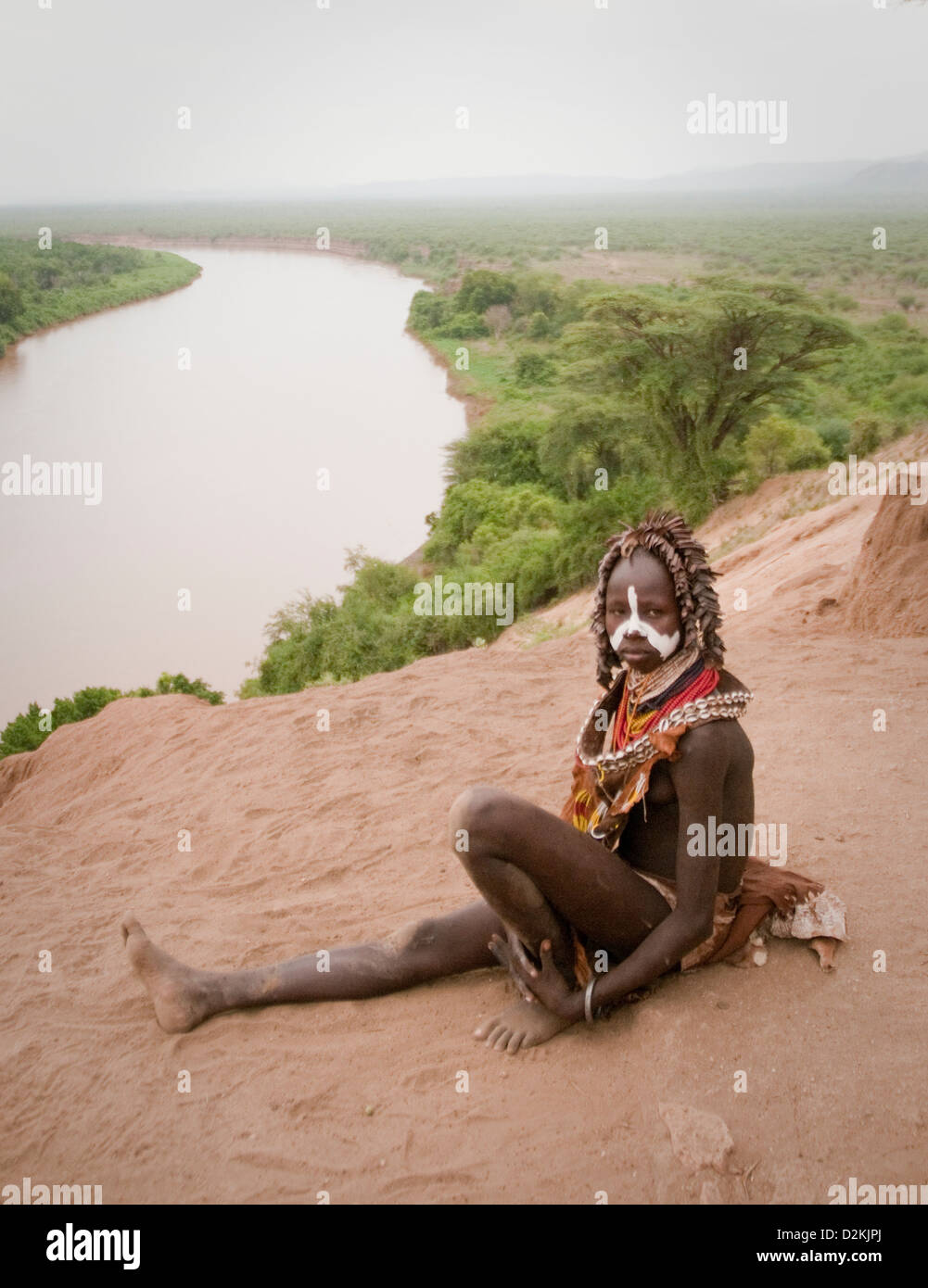 Decorated Kara woman sitting on bluff above Omo River Stock Photo - Alamy
