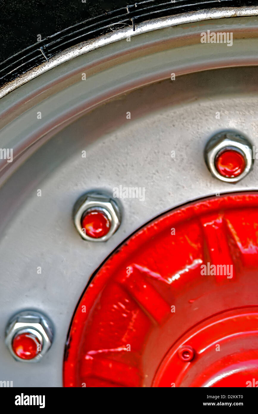 Large red wheel rim with screws, for machinery used in agriculture ...