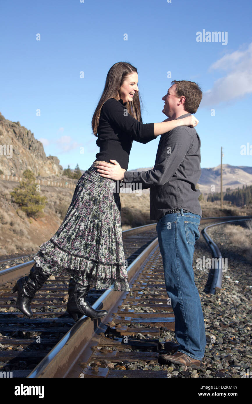 a young couple on the train tracks Stock Photo - Alamy
