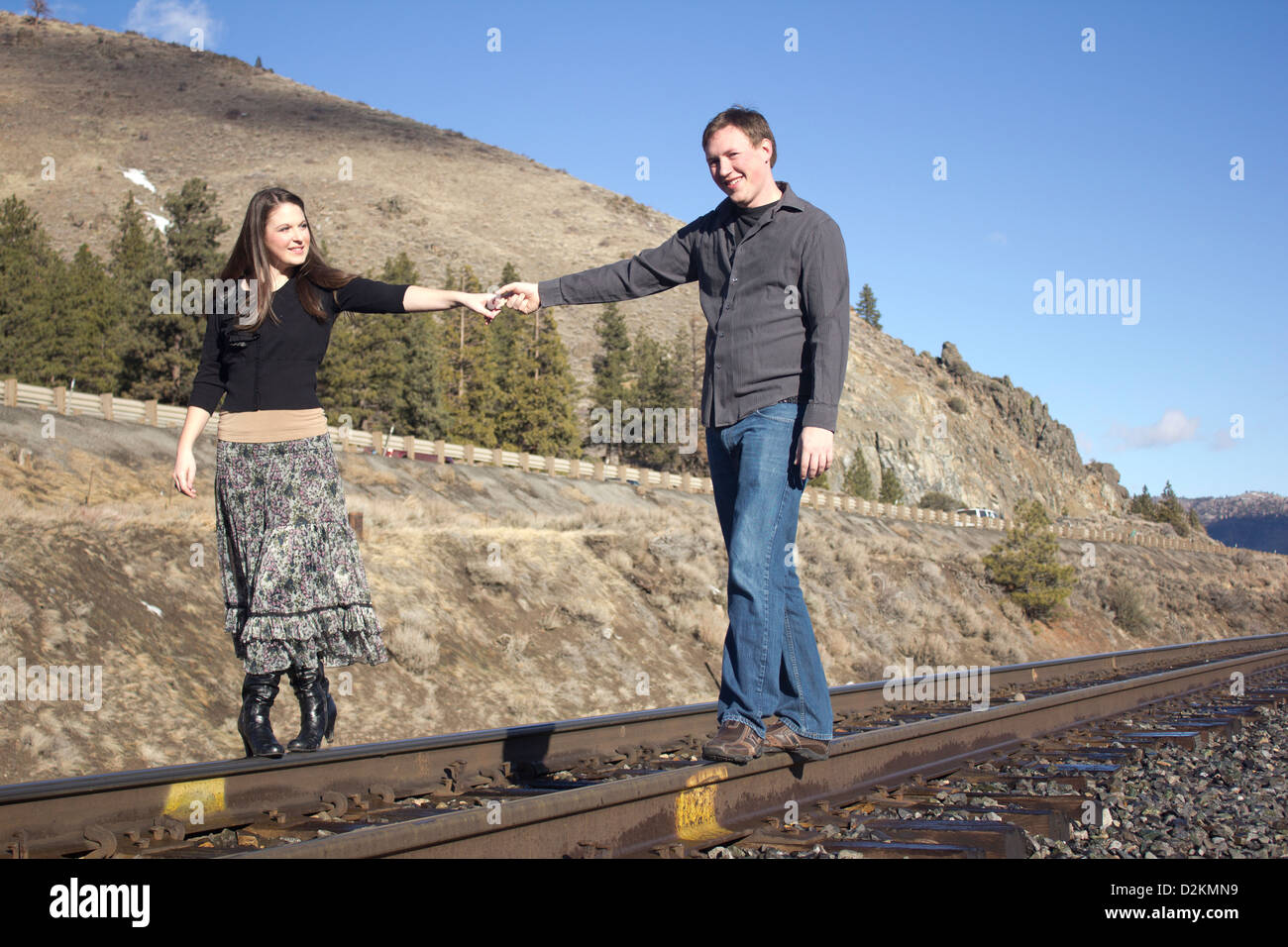 a young couple on the train tracks Stock Photo - Alamy