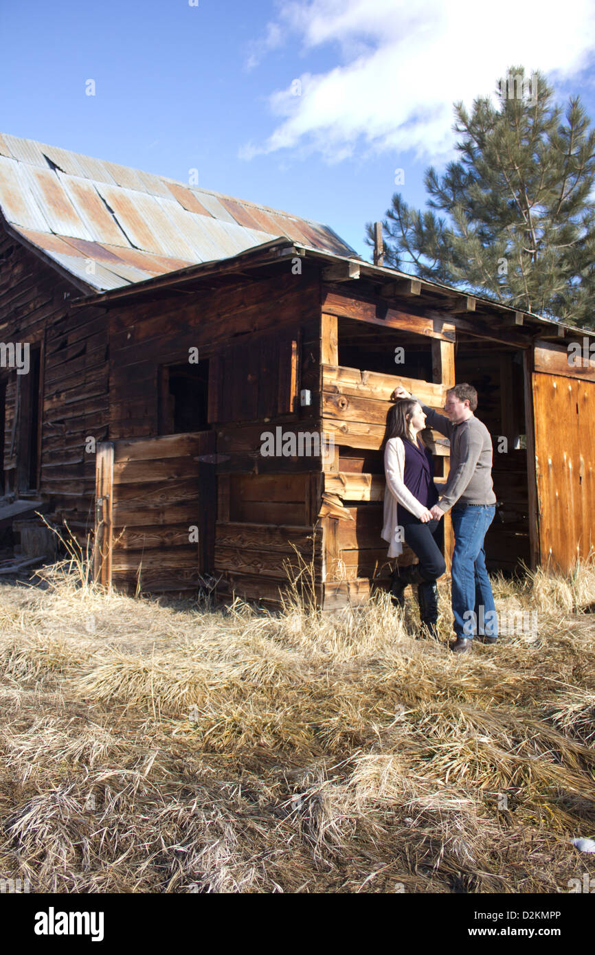 a young couple in love by an old barn Stock Photo - Alamy