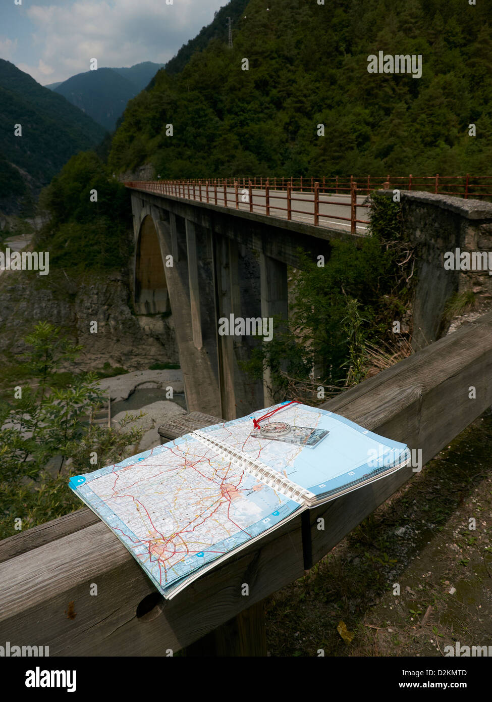 Map and compass with road and bridge in backgroundMap and compass with ...