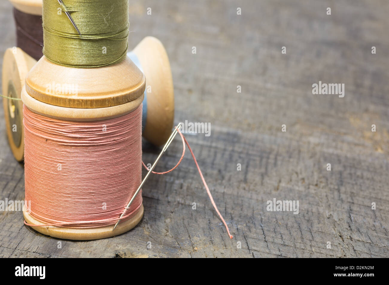 Spools of sewing thread stacked on a table Stock Photo - Alamy