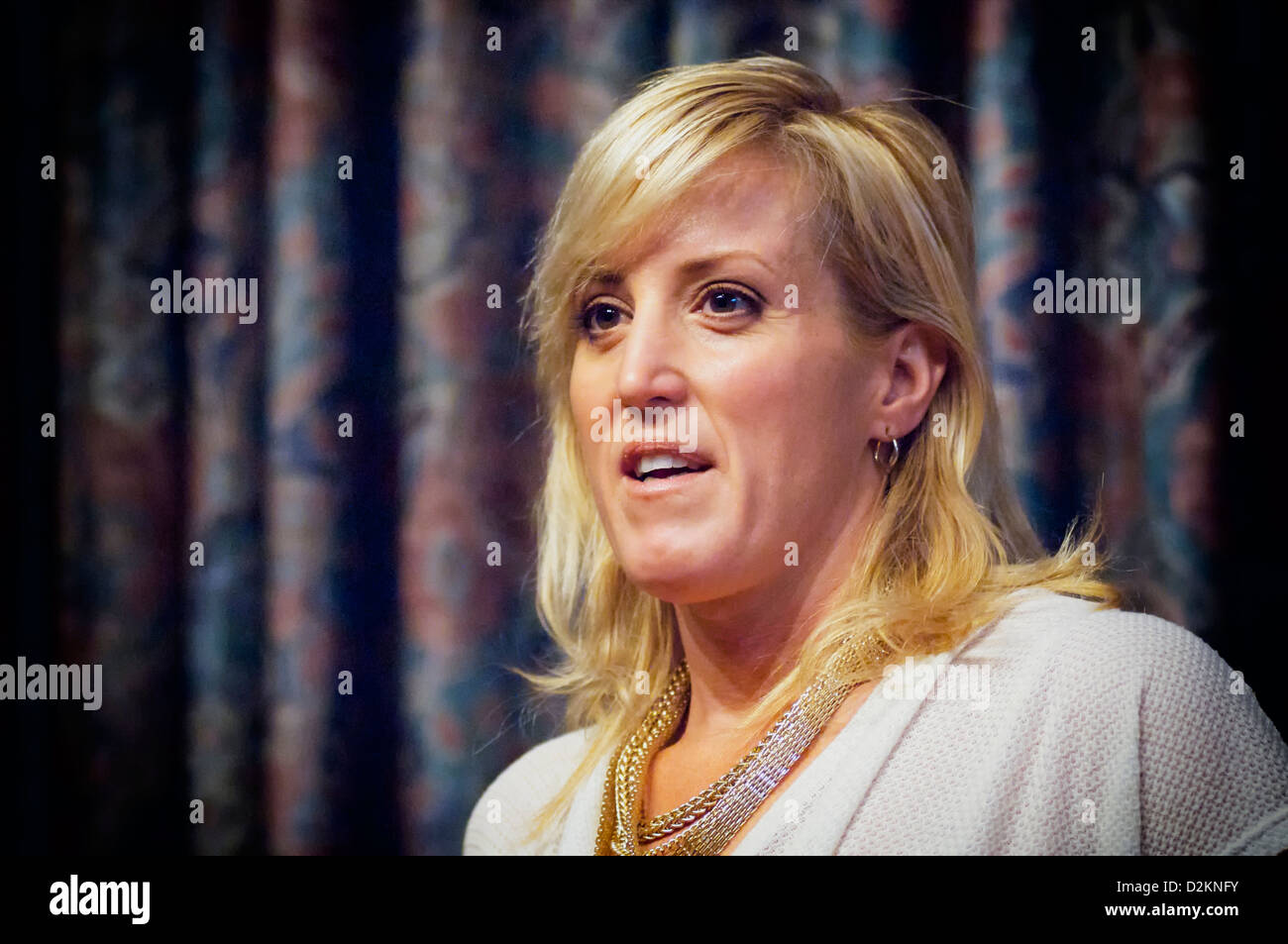 Head shot of Michele McPhee standing at podium dark background Stock ...