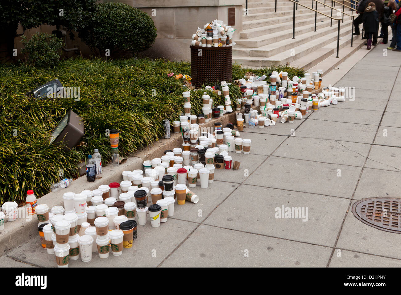 Discarded coffee cups overflowing from trash bin on public street Stock ...
