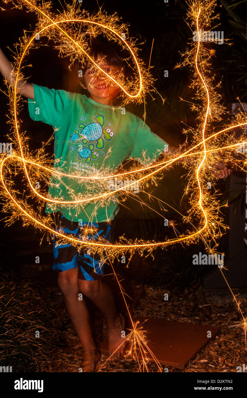 8 year old boy playing with sparkler Stock Photo - Alamy