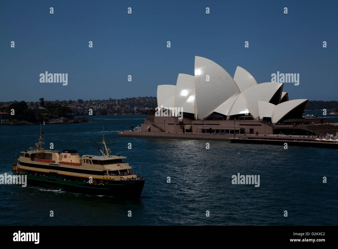 A ferry goes past the Sydney Opera House in the harbor, Australia Stock ...