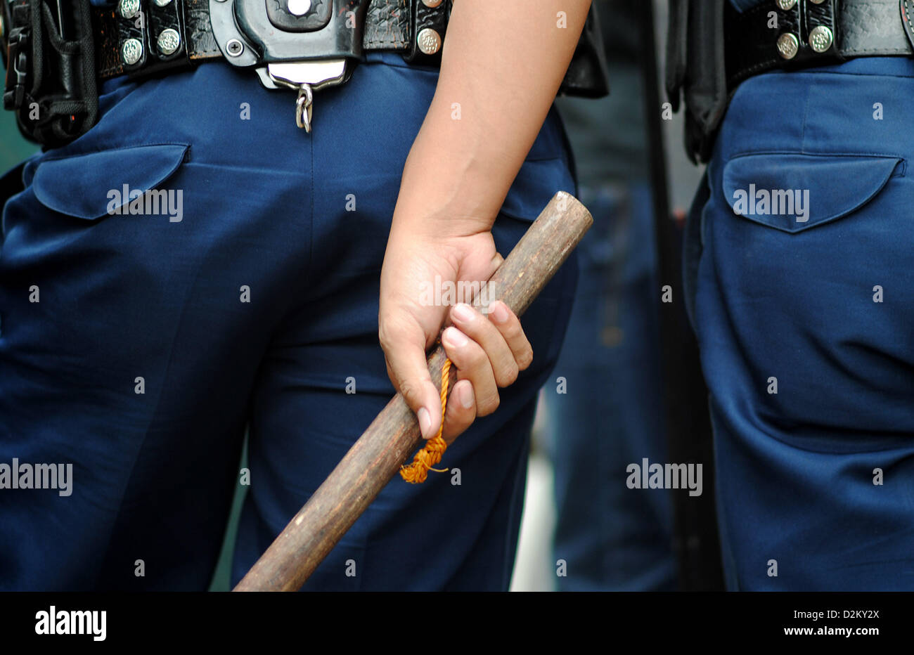 Manila, Philippines. 28th January 2013. A police officer keeps a baton ...