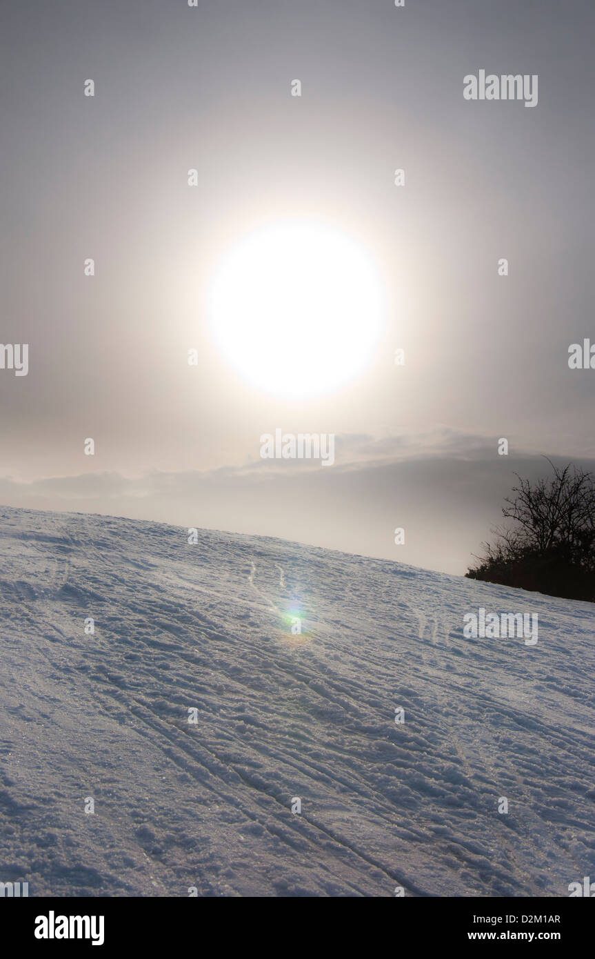 Snow on hill with sun Stock Photo - Alamy