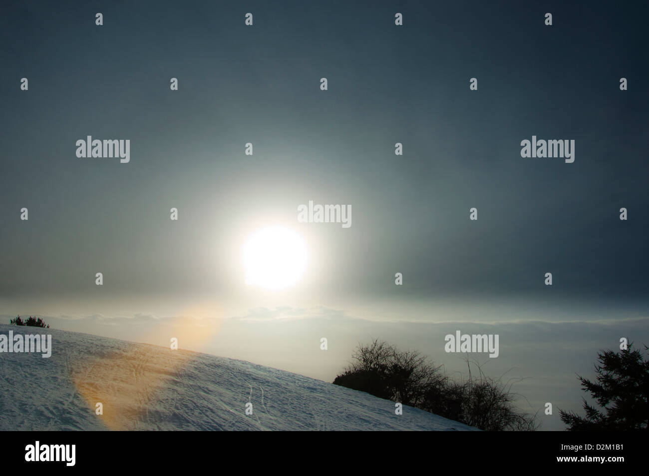 Snow on hill with sun Stock Photo - Alamy