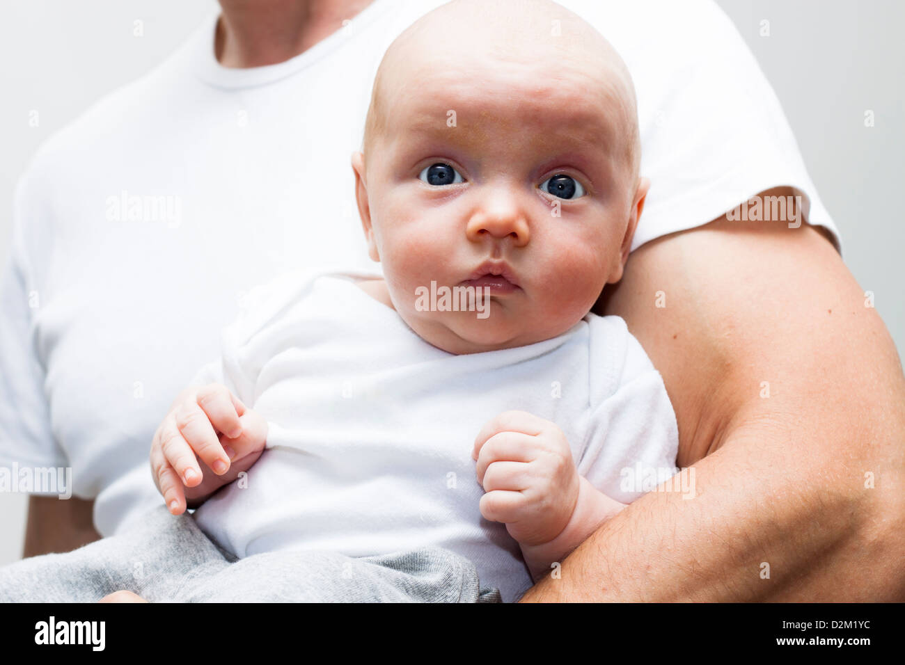 Close up of cute baby boy and male father arm Stock Photo - Alamy