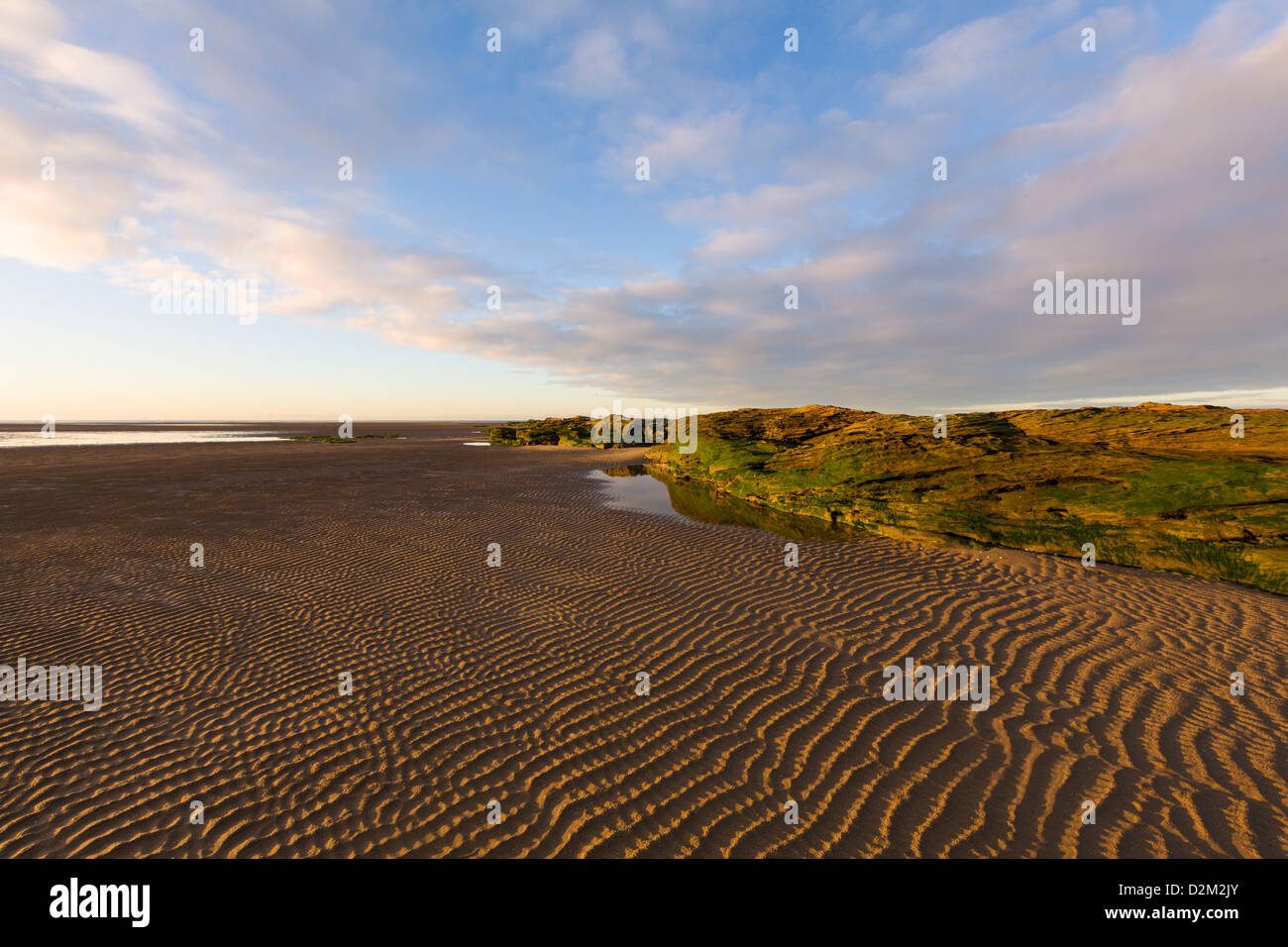 Rippled sand and sandstone rocks at low tide, Wirral, England Stock ...