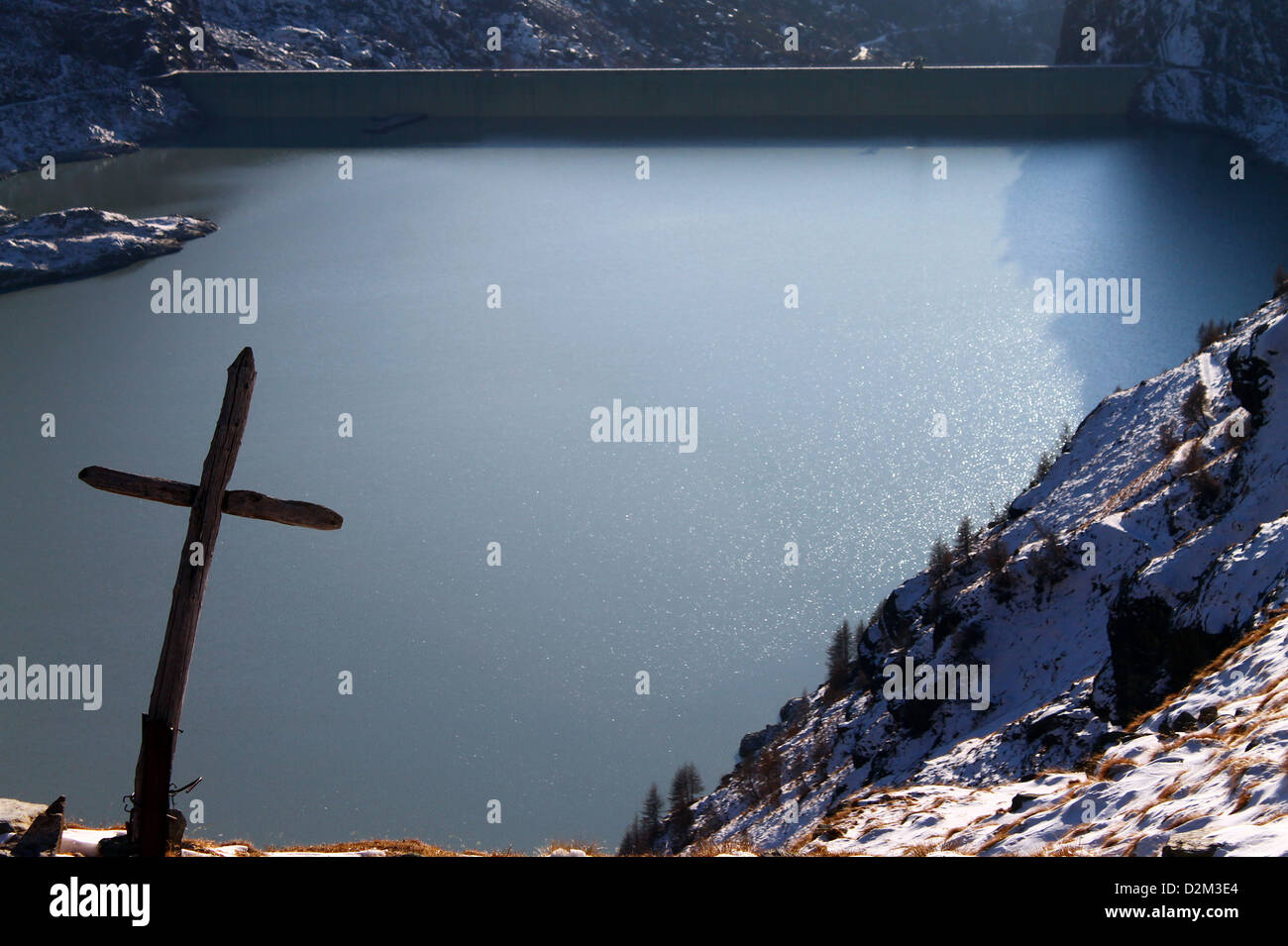 Mountain lake with a cross and snow in Northern Italy Stock Photo - Alamy
