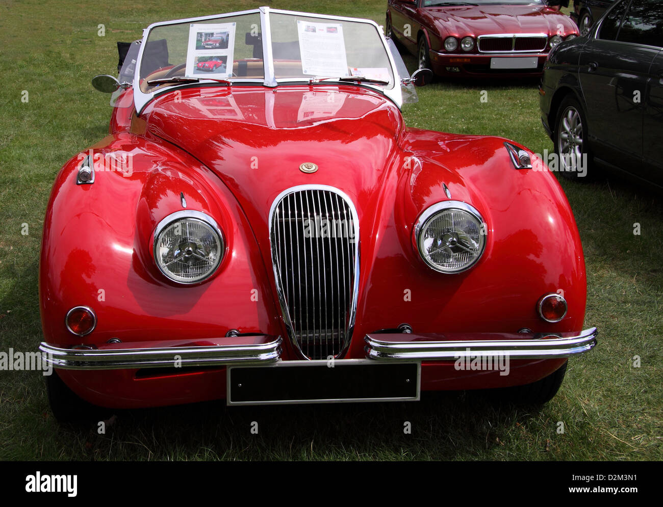 A bright red Jaguar sports car on display at a classic car show in ...
