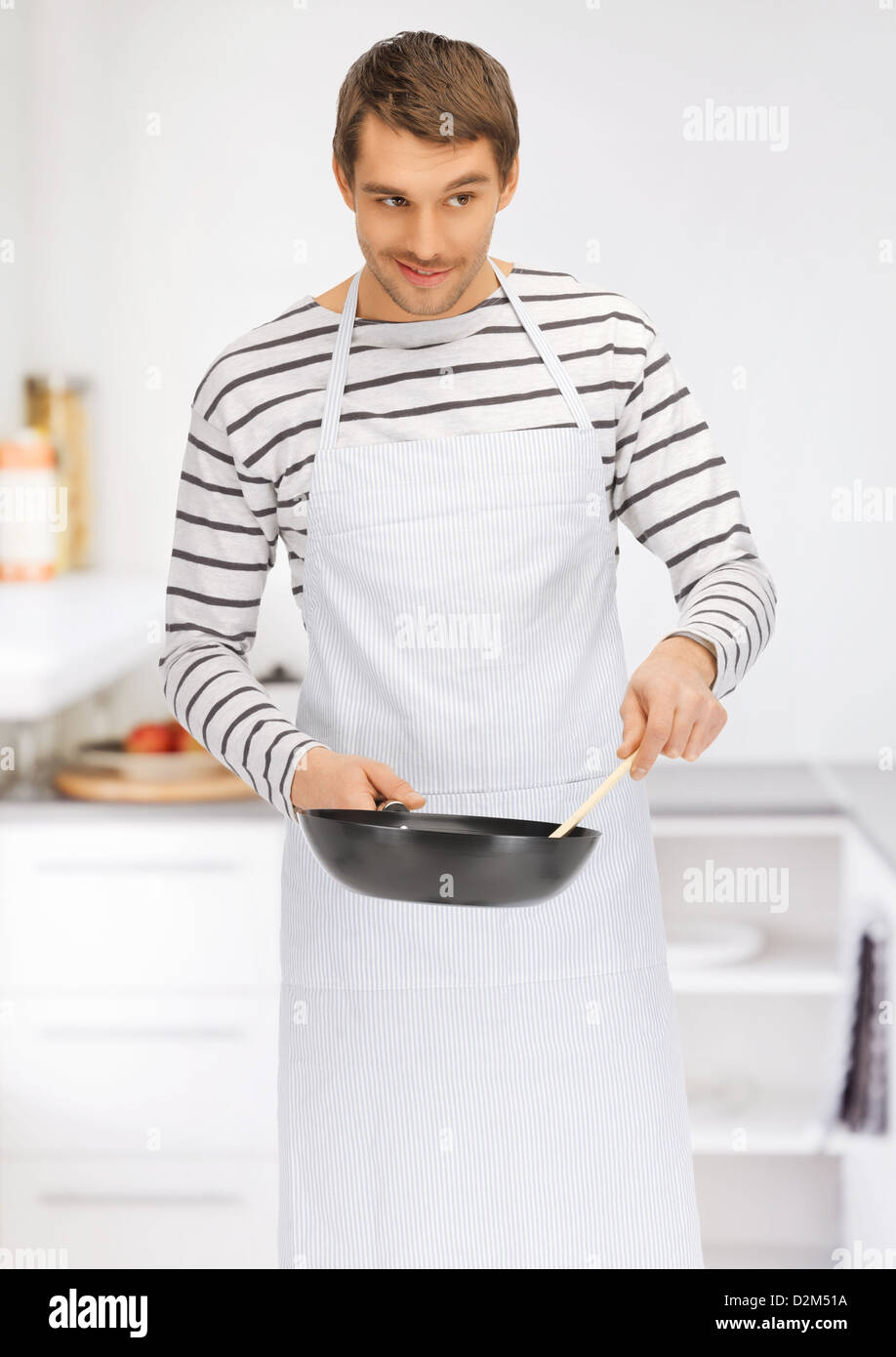 handsome man with pan at kitchen Stock Photo - Alamy