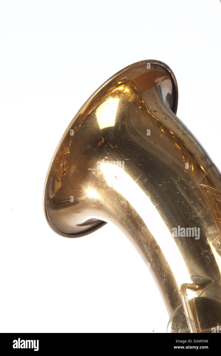 Close up shot of the bell of a tenor saxophone shot against a white ...