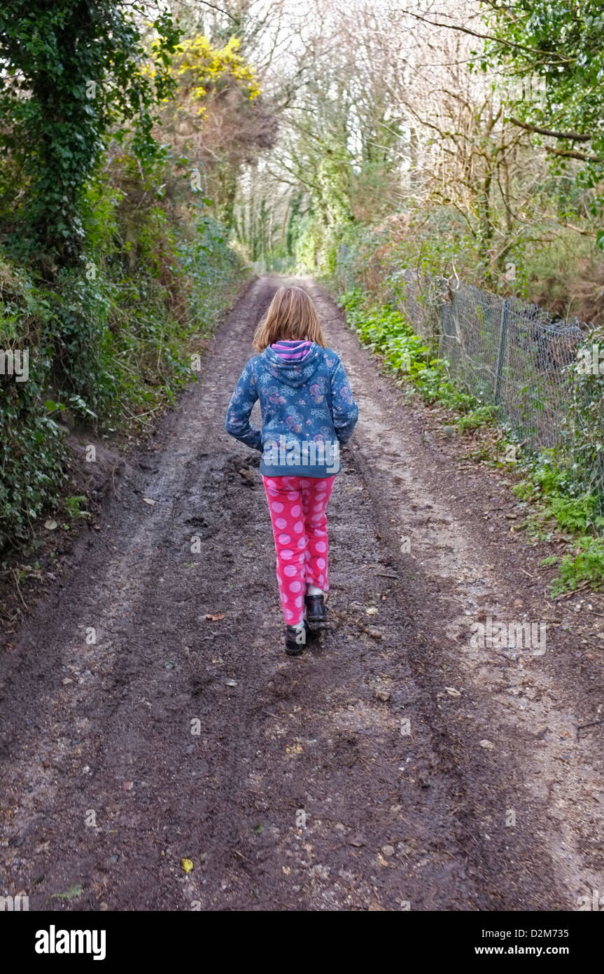 A girl walking along a country path Stock Photo - Alamy