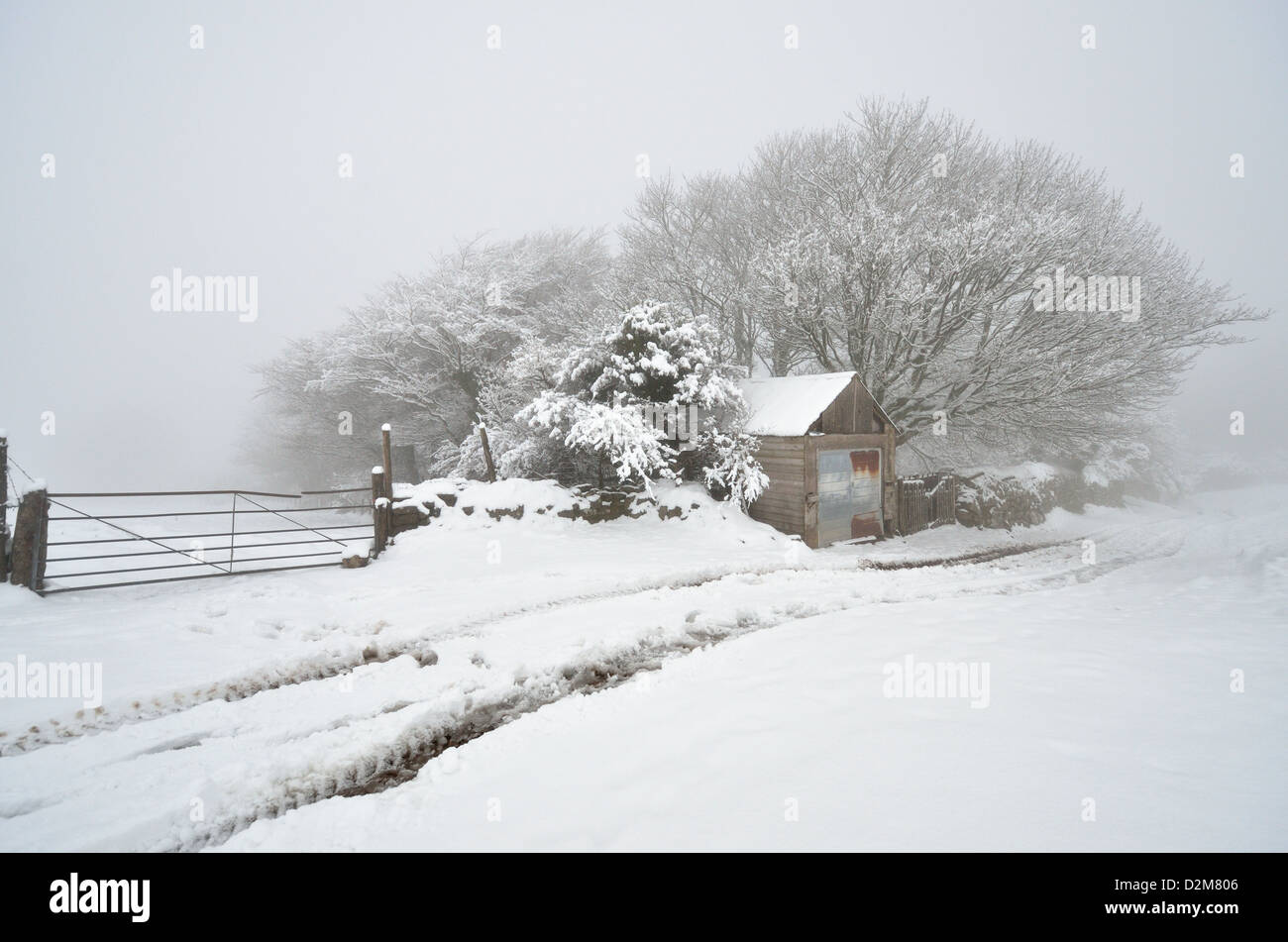 Snow and Fog isolate a garage on the edge of Dartmoor. Rust on the ...