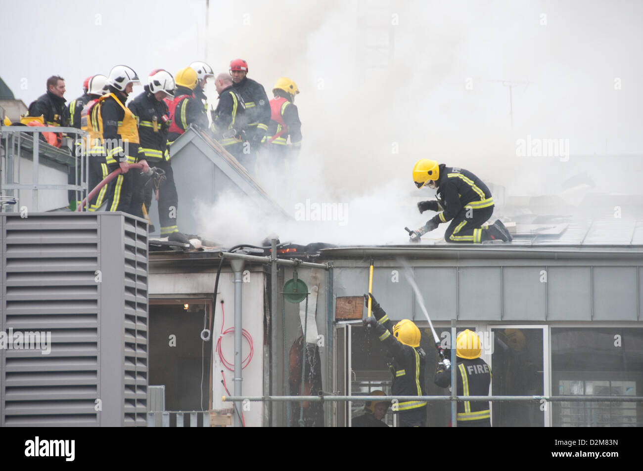 London, UK. 28th January 2013. Fire fighters putting out a rooftop fire ...