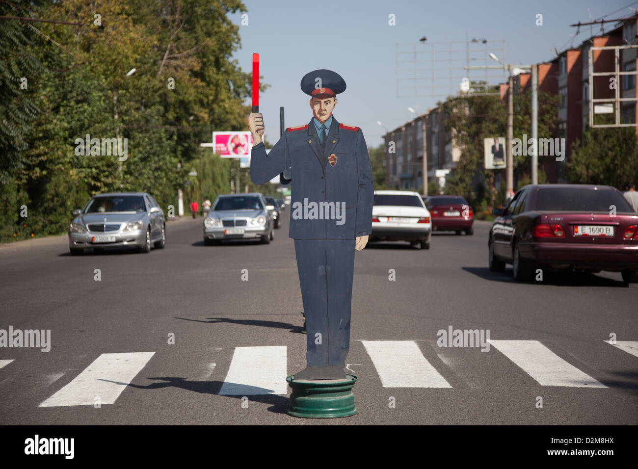 A fake policeman signals a crosswalk in Osh, southern Kyrgyzstan Stock ...
