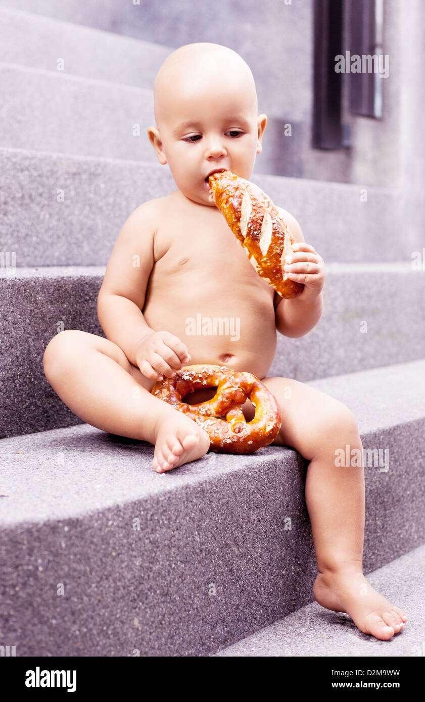 happy baby eating bread Stock Photo - Alamy