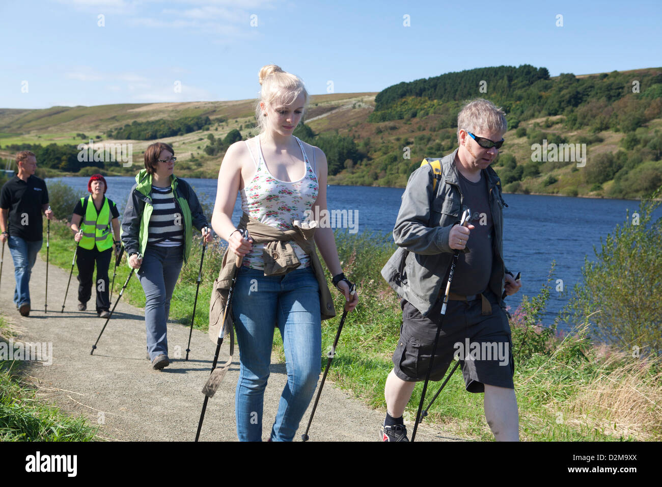 Walking group in West Yorkshire on a Summers day hiking along the trail ...