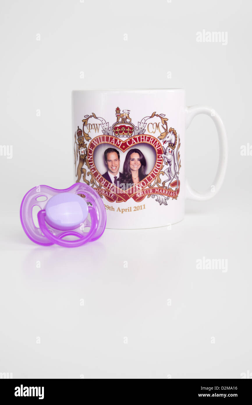 Symbolic picture of a cup an a pink pacifier Stock Photo - Alamy