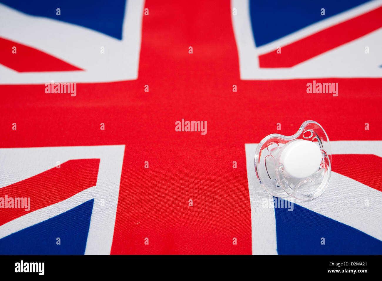 Symbolic picture of a pacifier on the british flag Stock Photo - Alamy