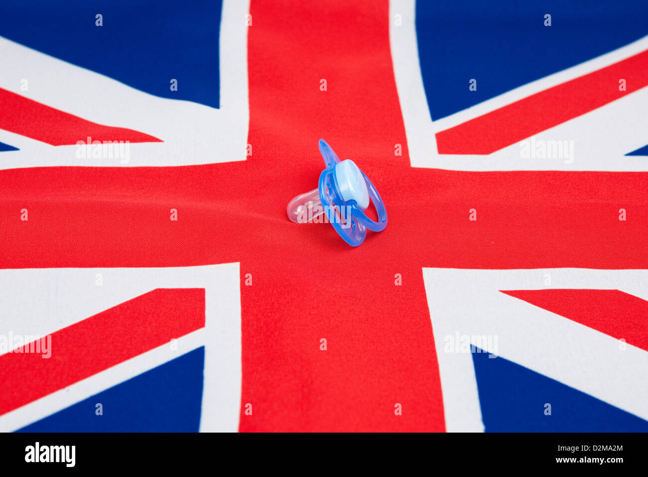 Symbolic picture of a blue pacifier on the british flag Stock Photo - Alamy