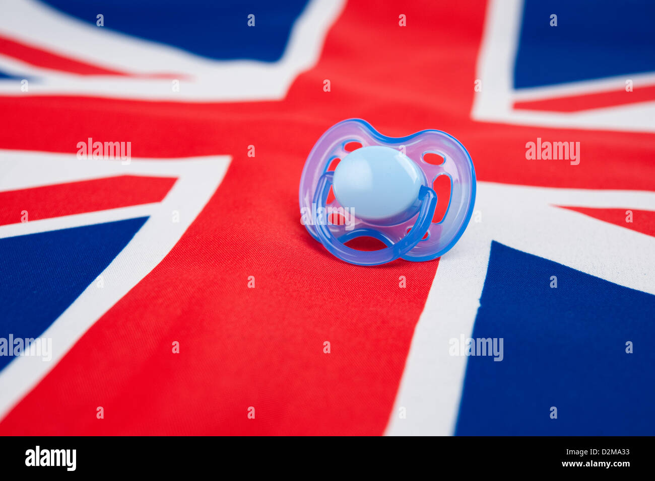 Symbolic picture of a blue pacifier on the british flag Stock Photo - Alamy
