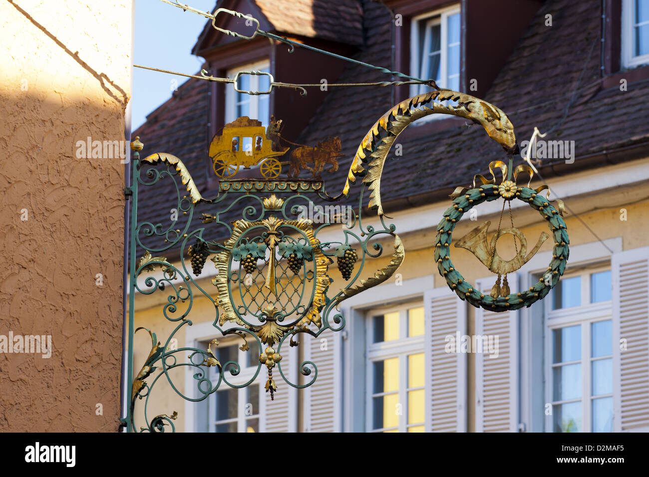 Wrought iron shield with golden sun for a guest house in old town of ...