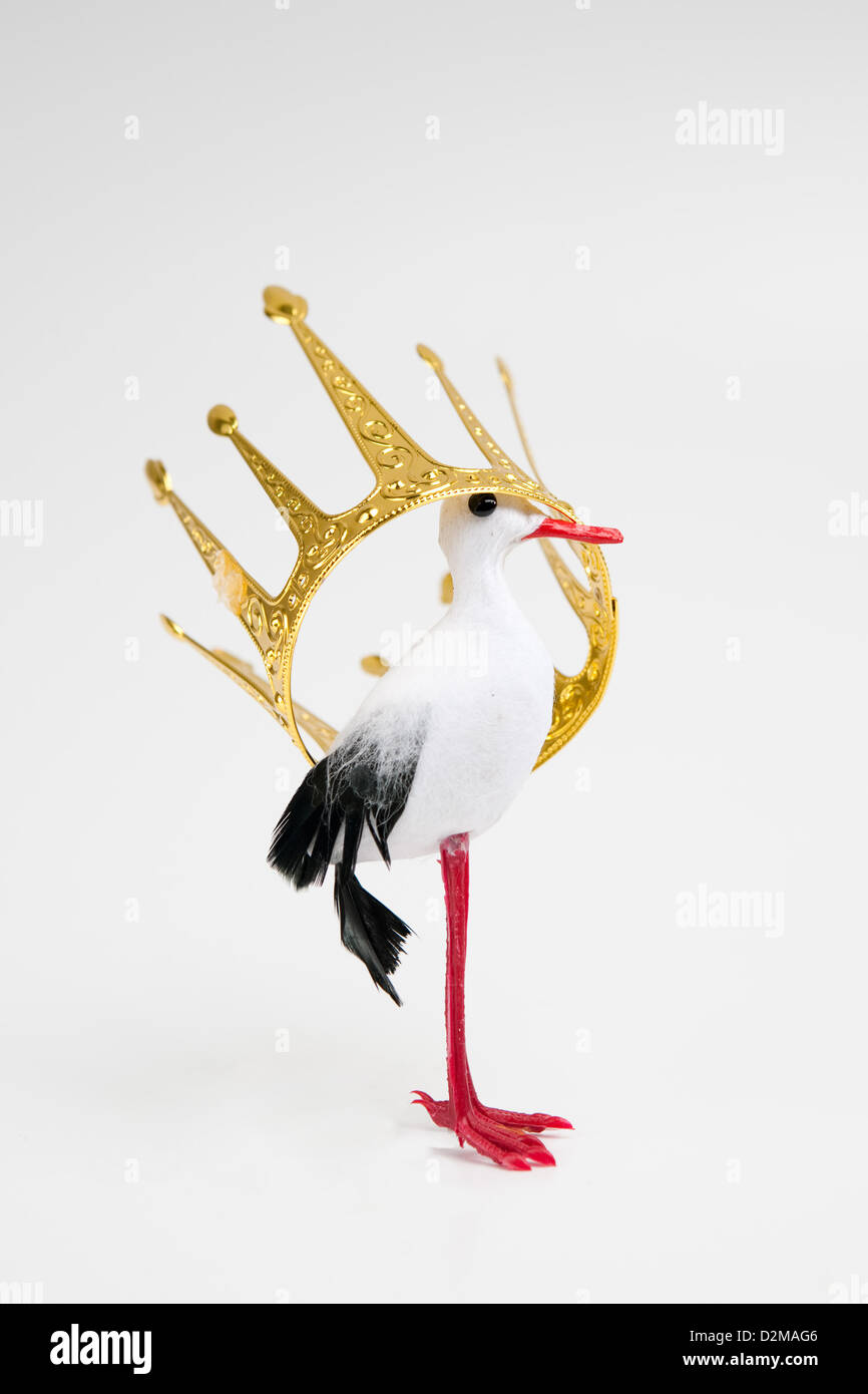 Symbolic picture with a crown an a stork Stock Photo - Alamy