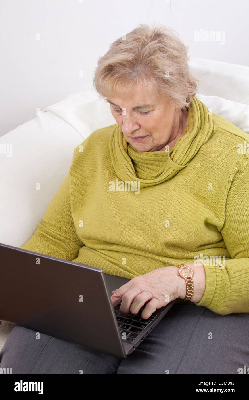 Mature lady using a laptop Stock Photo - Alamy