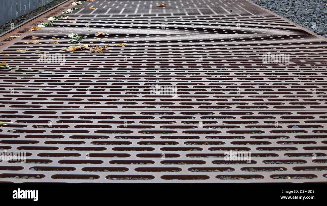 White roses lie on the steel plates of the Platform 17 memorial site at ...