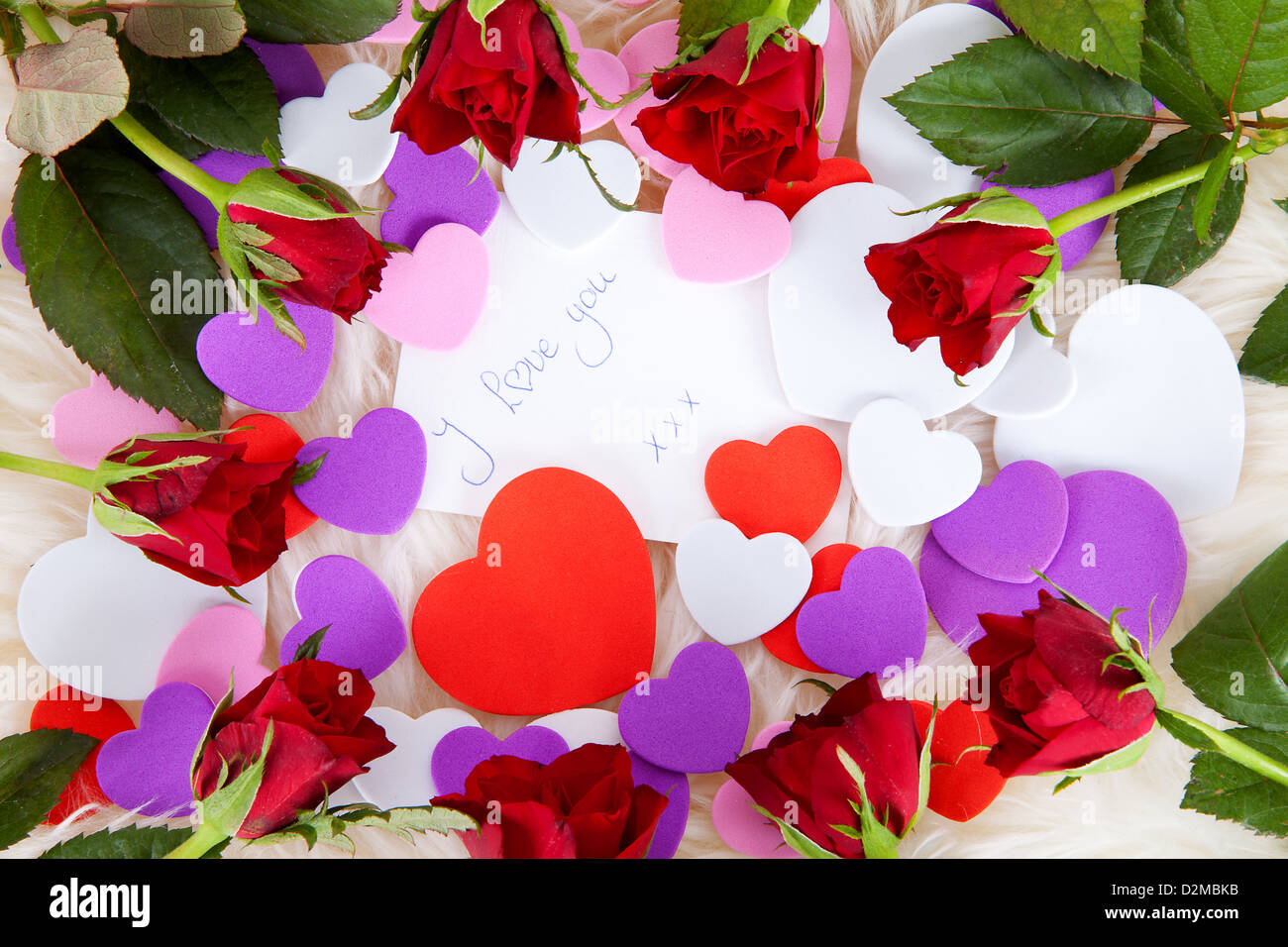 Romantic note: I love with red roses and hearts Stock Photo - Alamy