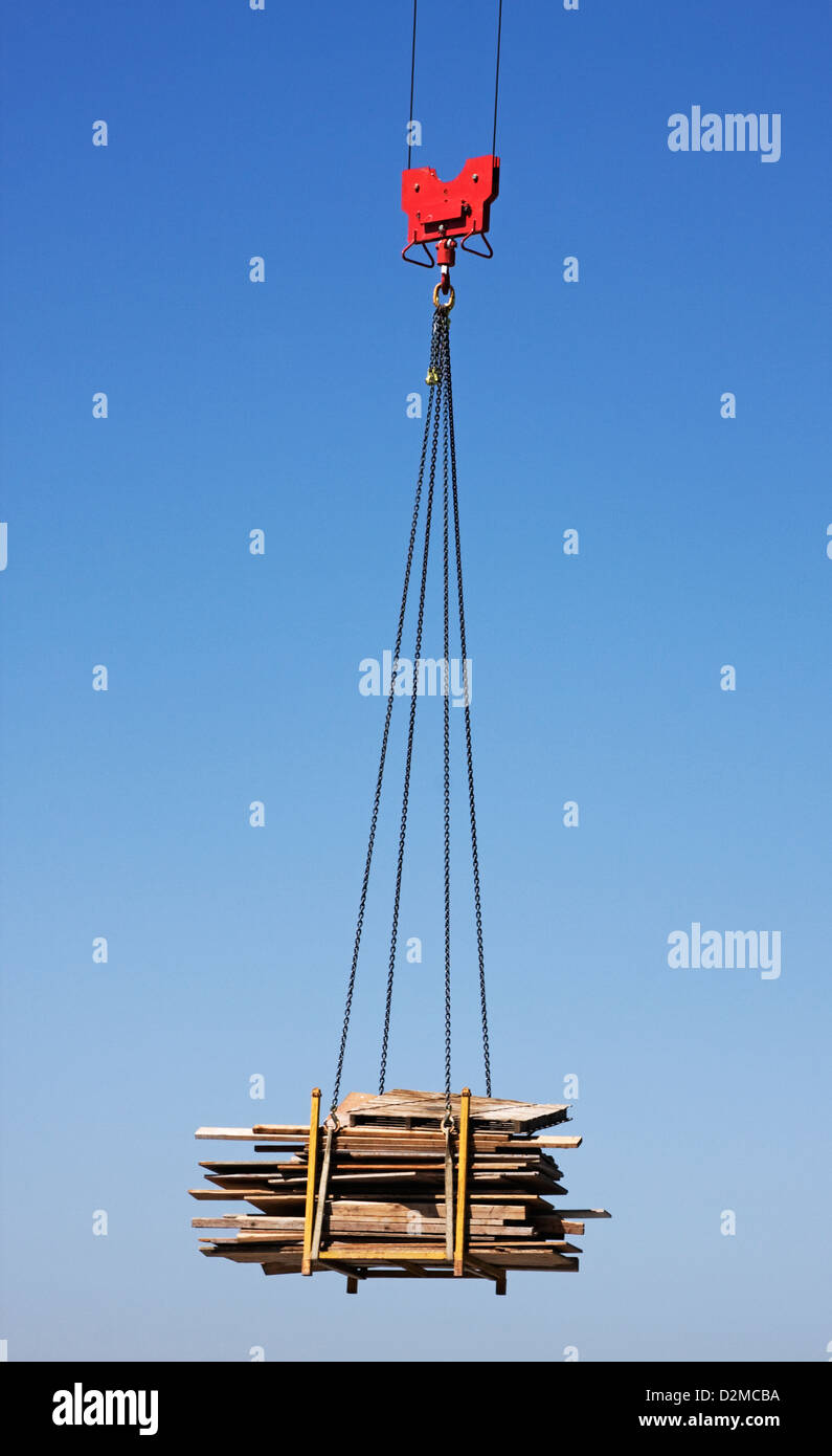 Construction crane lifting materials Stock Photo - Alamy