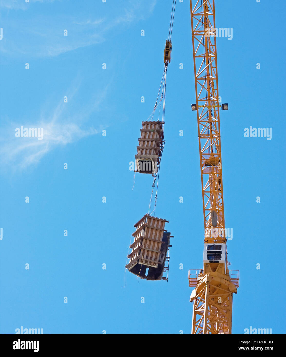 Construction crane lifting materials Stock Photo - Alamy