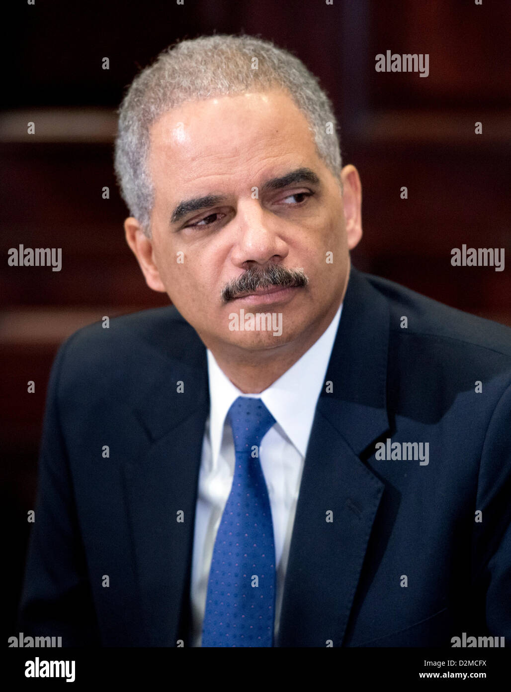 United States Attorney General Eric Holder listens as U.S. President ...