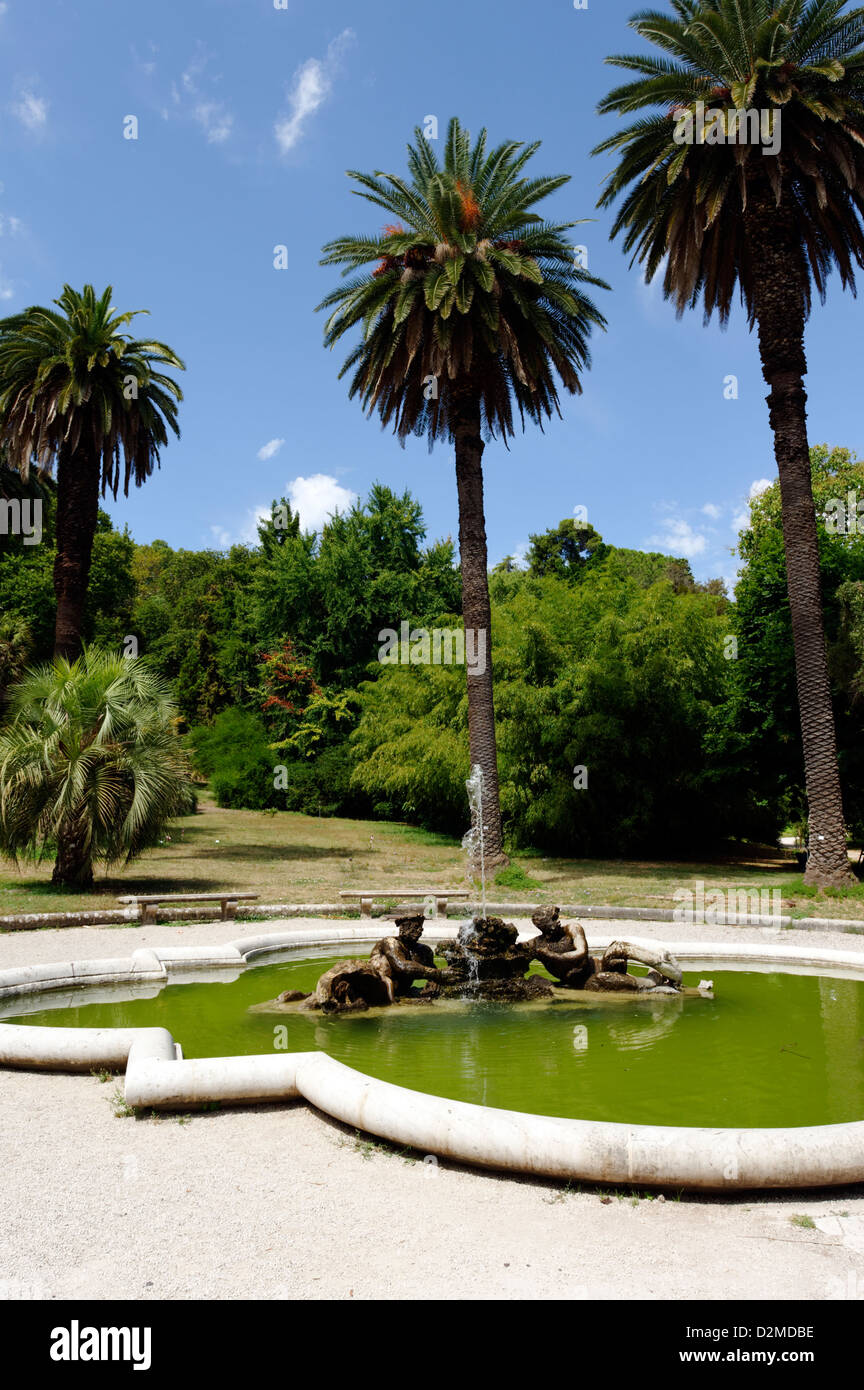 Rome. Italy. Palm trees surrounding the fountain of the tritons at the ...