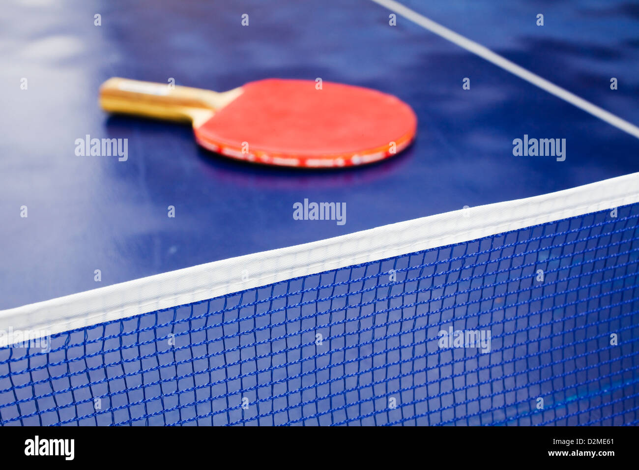 Red Ping Pong paddle on ping pong table Stock Photo - Alamy