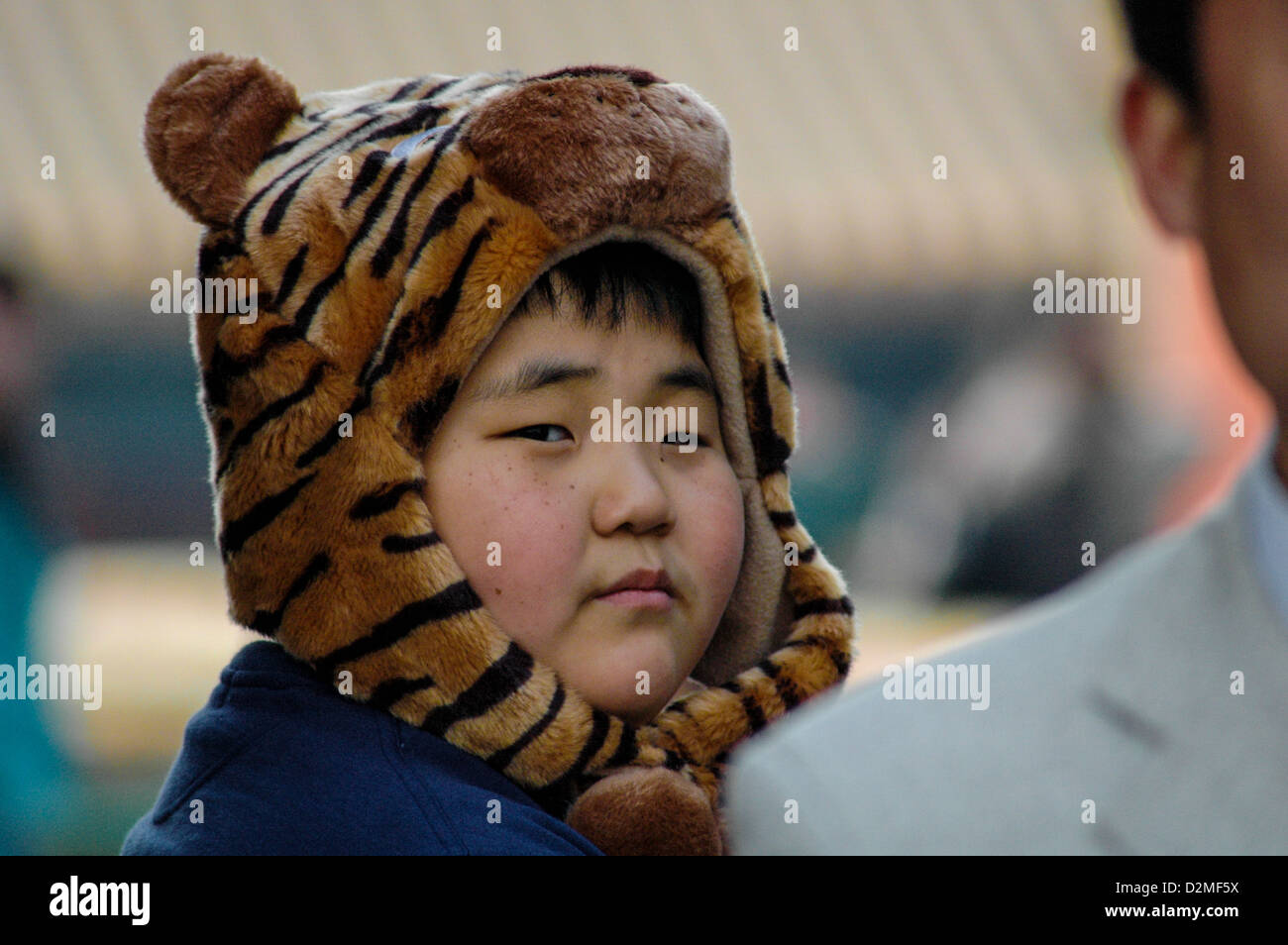 Chinese child with tiger hat on Stock Photo - Alamy