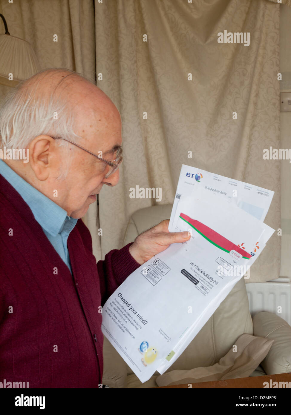 elderly man looking at household utility bills Stock Photo - Alamy