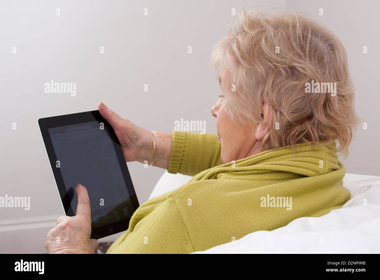 Mature lady using a digital tablet Stock Photo - Alamy