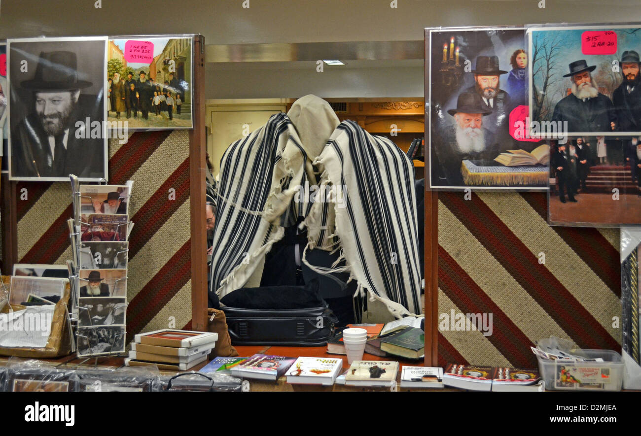 Framed by photos of the Rebbe, Menachem Mendel Schneerson, a man ...