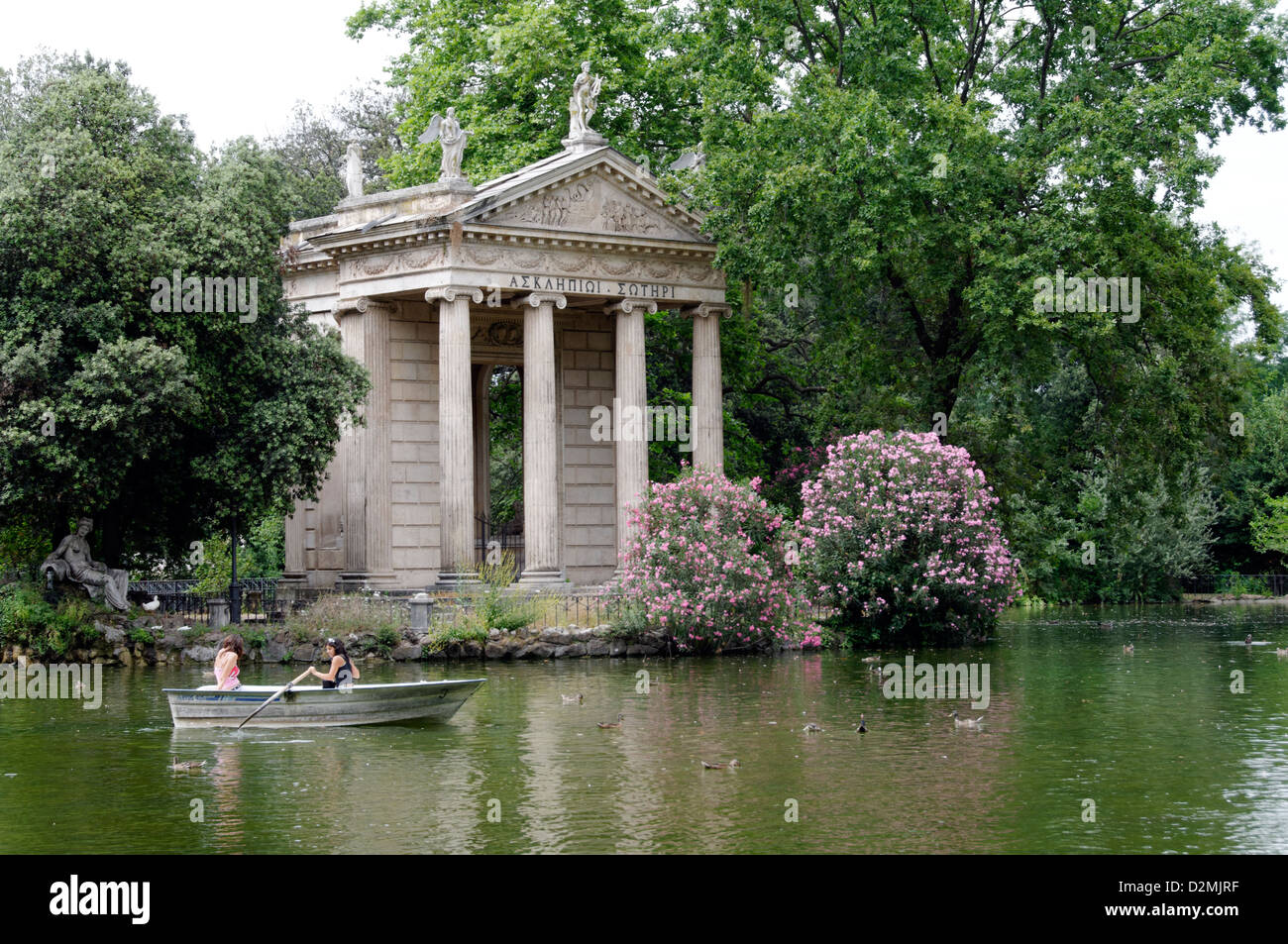 Rome. Italy. People in boats rowing around the Ionic Temple of ...