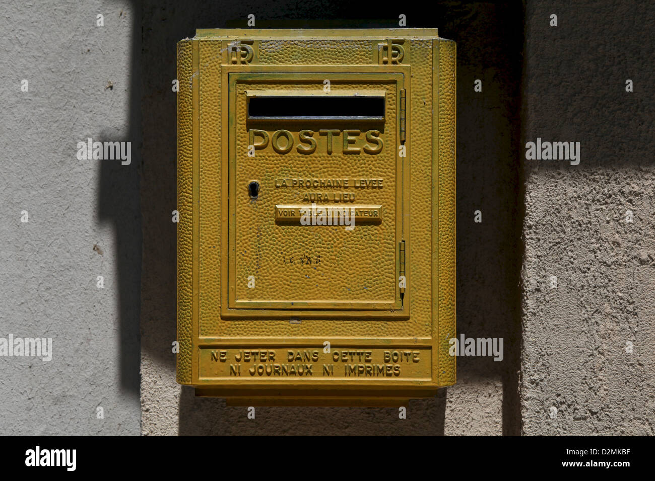 An old French yellow mailbox with "Postes" written on it Stock Photo ...