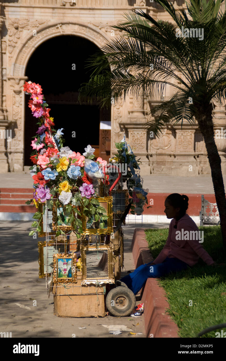 Artificial flowers on sale in a plaza by a cathedral in a small town in ...